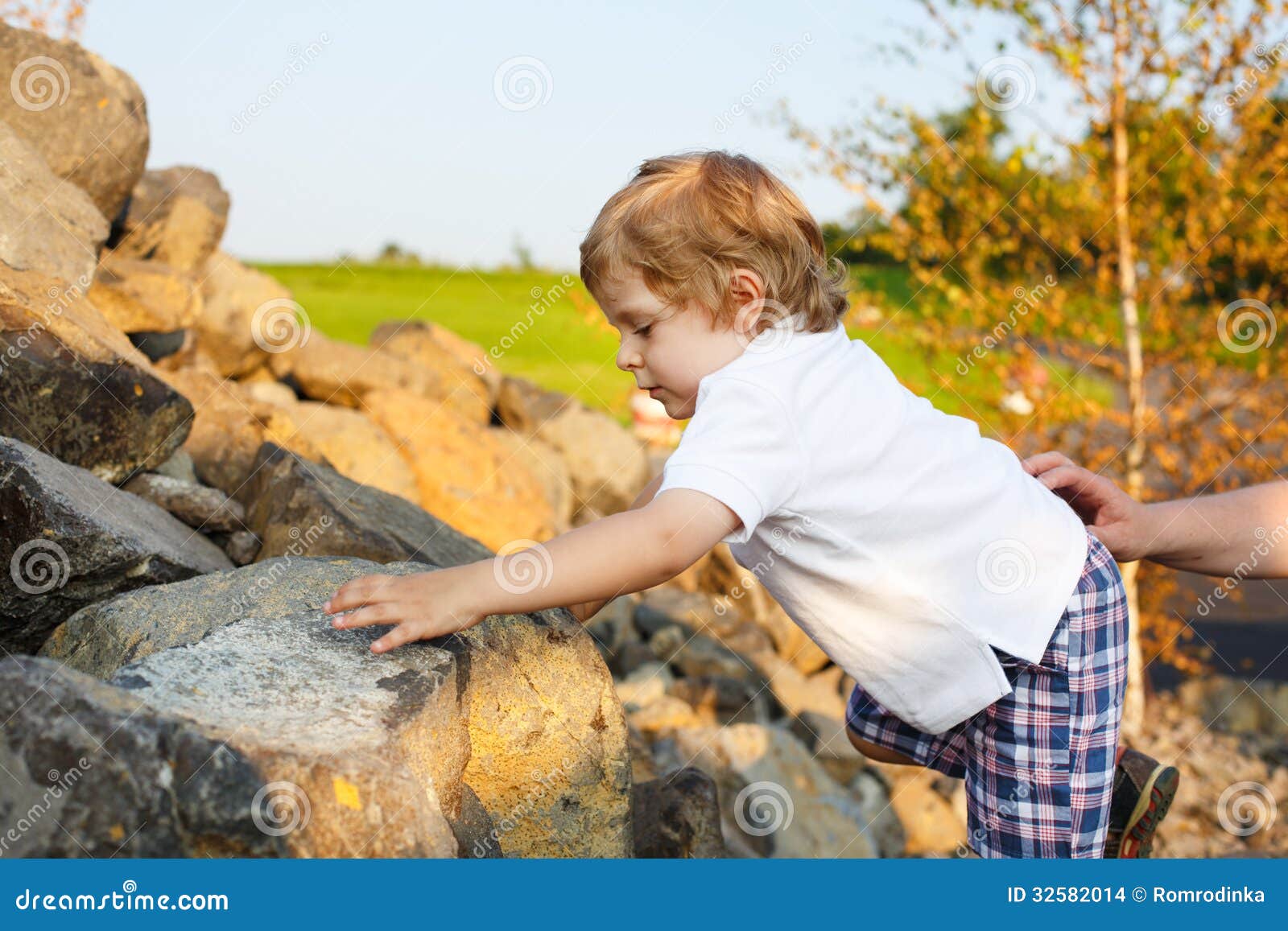 Little Boy Climbing Outdoors on Summer Evening Stock Photo - Image of ...