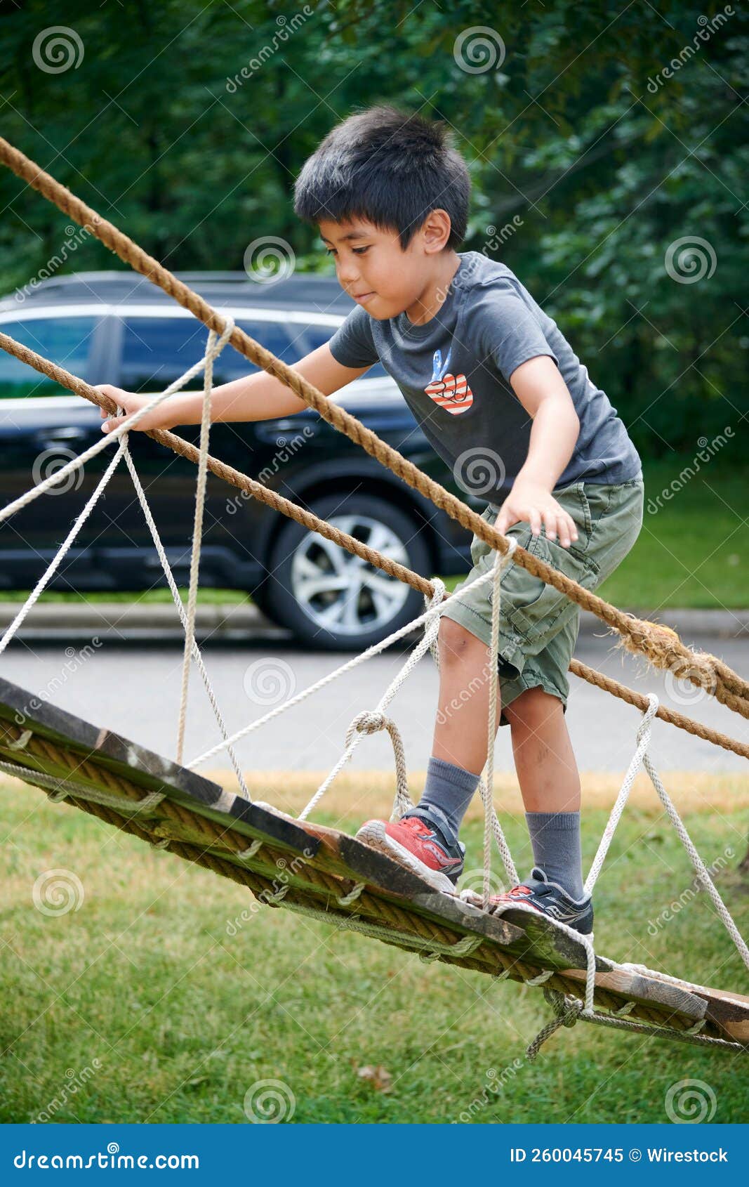 Little Boy Climbing a Wooden Bridge Stock Image - Image of small ...