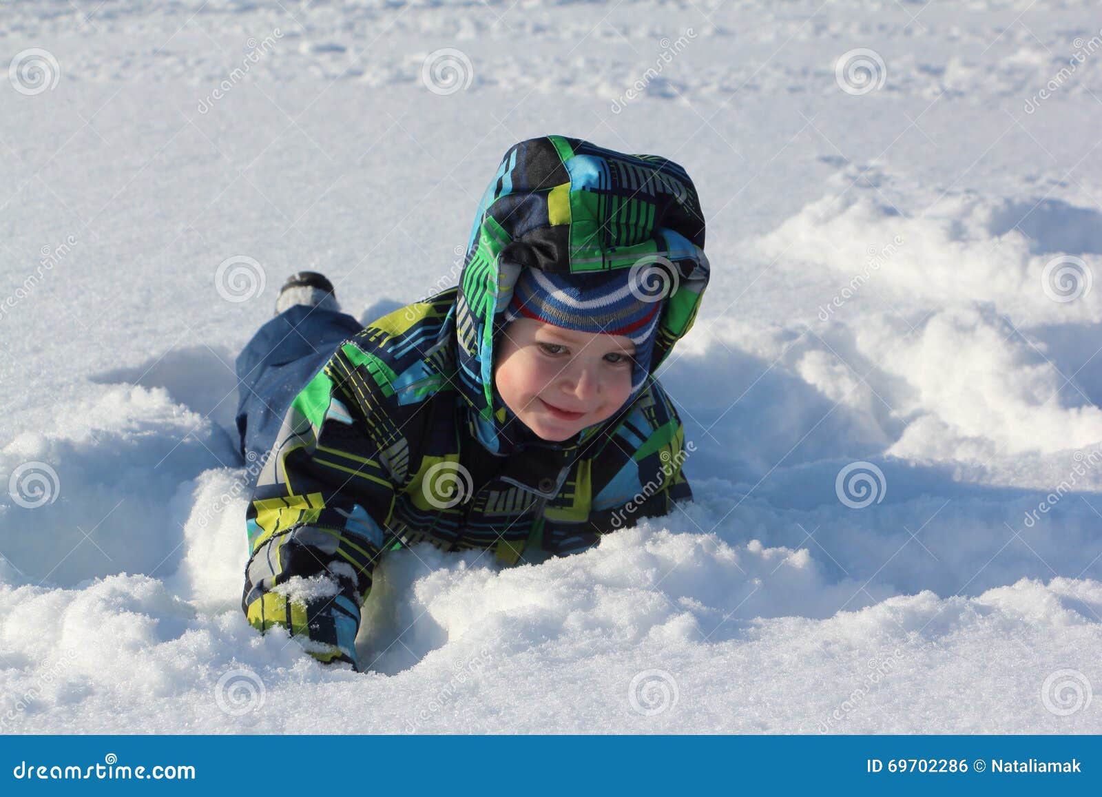 The Little Boy in a Color Jacket Creeping on Snow Stock Photo - Image ...