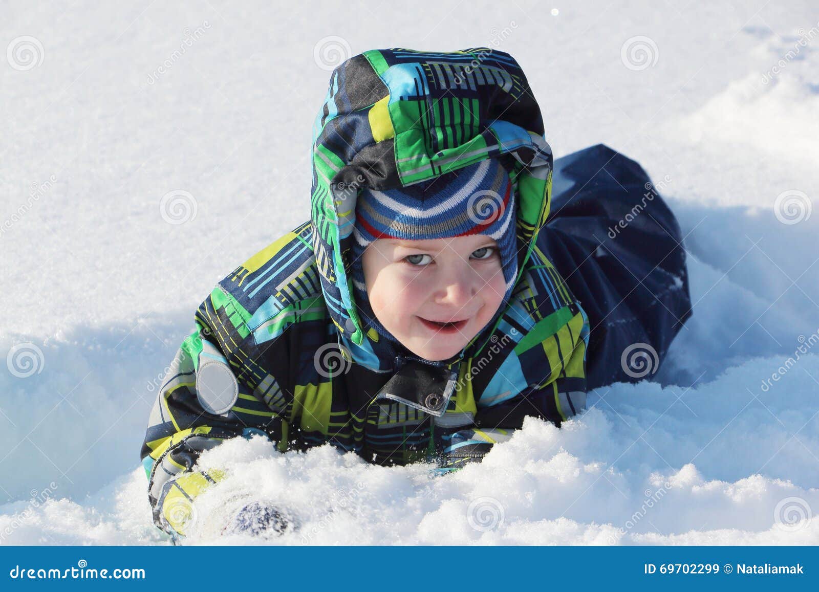 The Little Boy in a Color Jacket Creeping on Snow Stock Image - Image ...