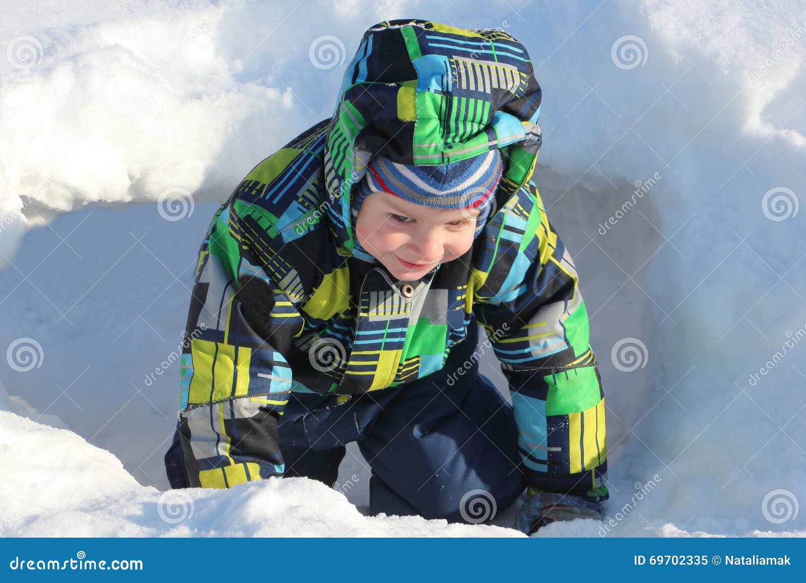 The Little Boy in a Color Jacket Creeping on Snow Stock Image - Image ...