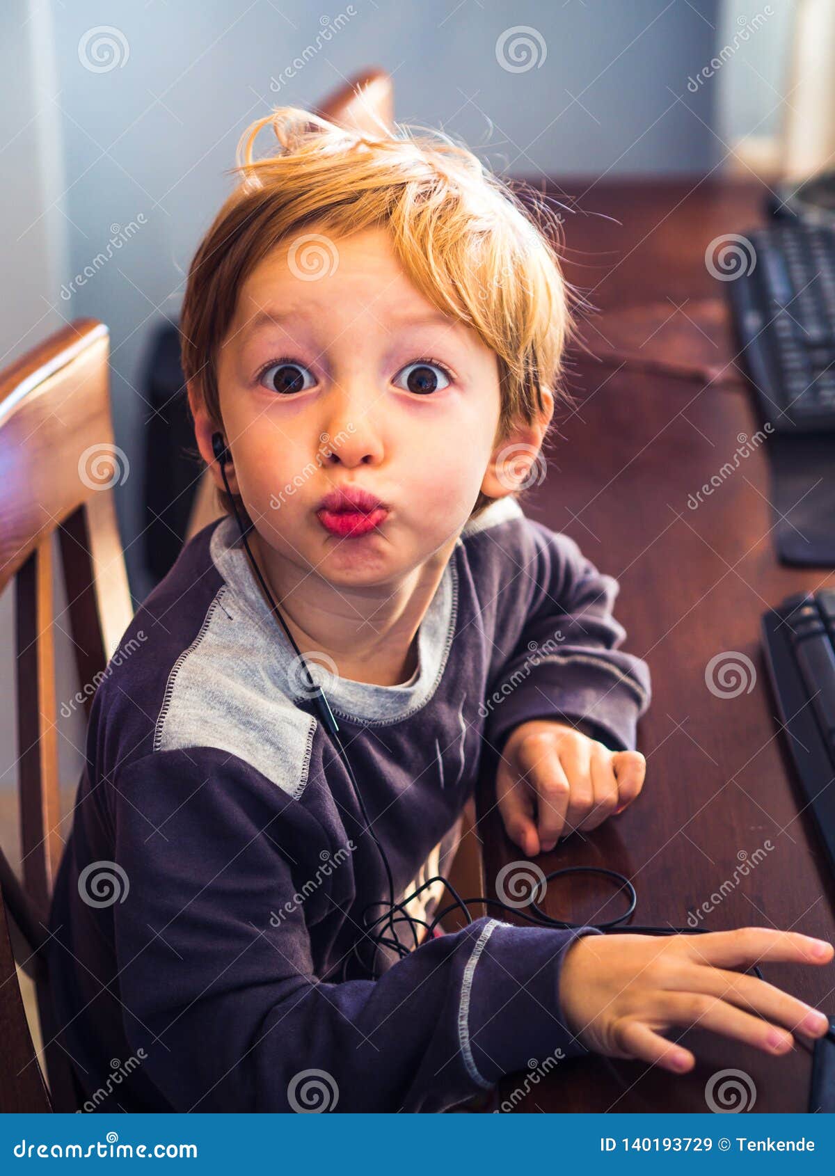 Little Boy at Computer with Headset. Funny Face Stock Image - Image of ...