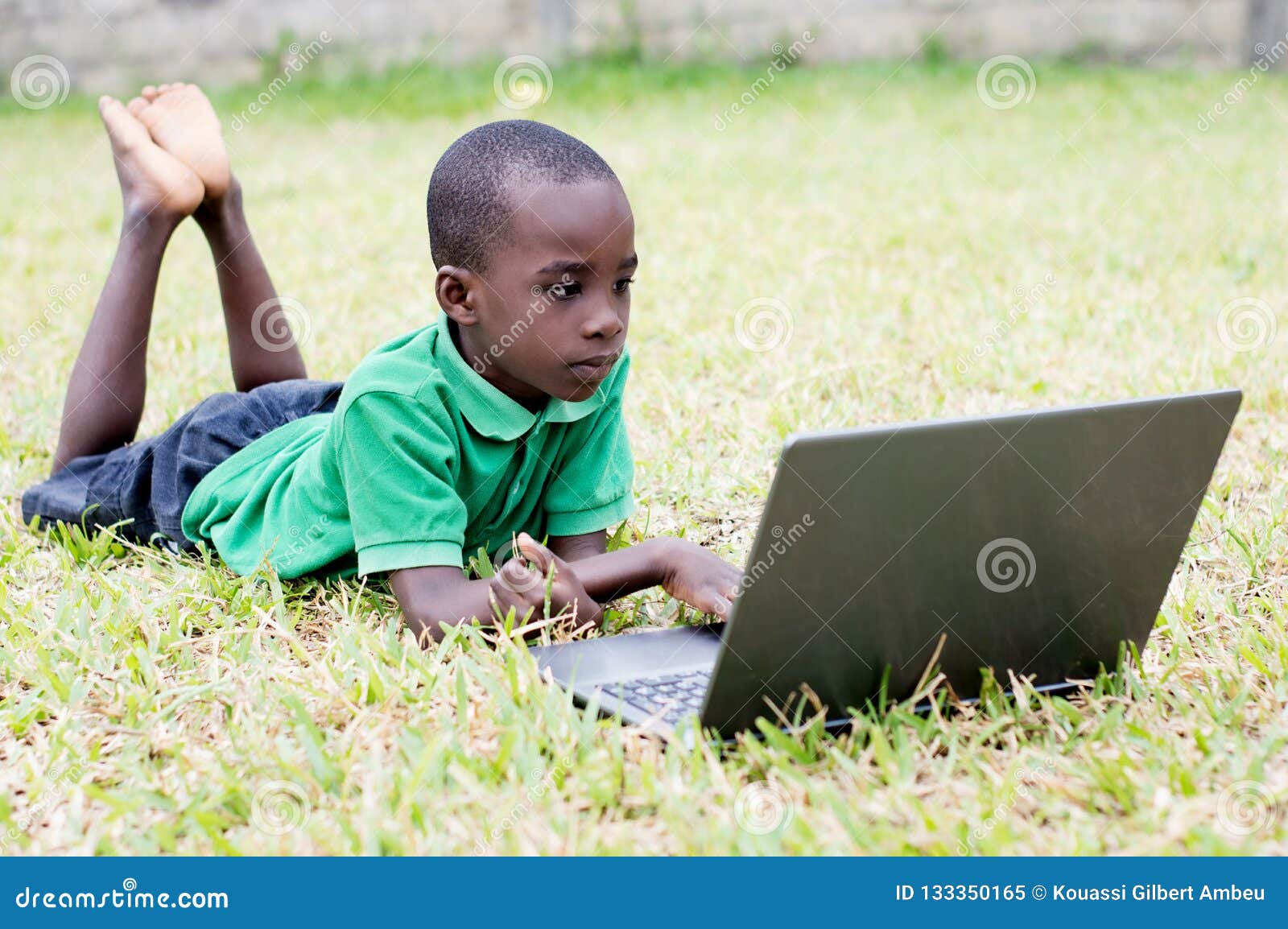 Little boy with computer stock image. Image of exterior - 133350165