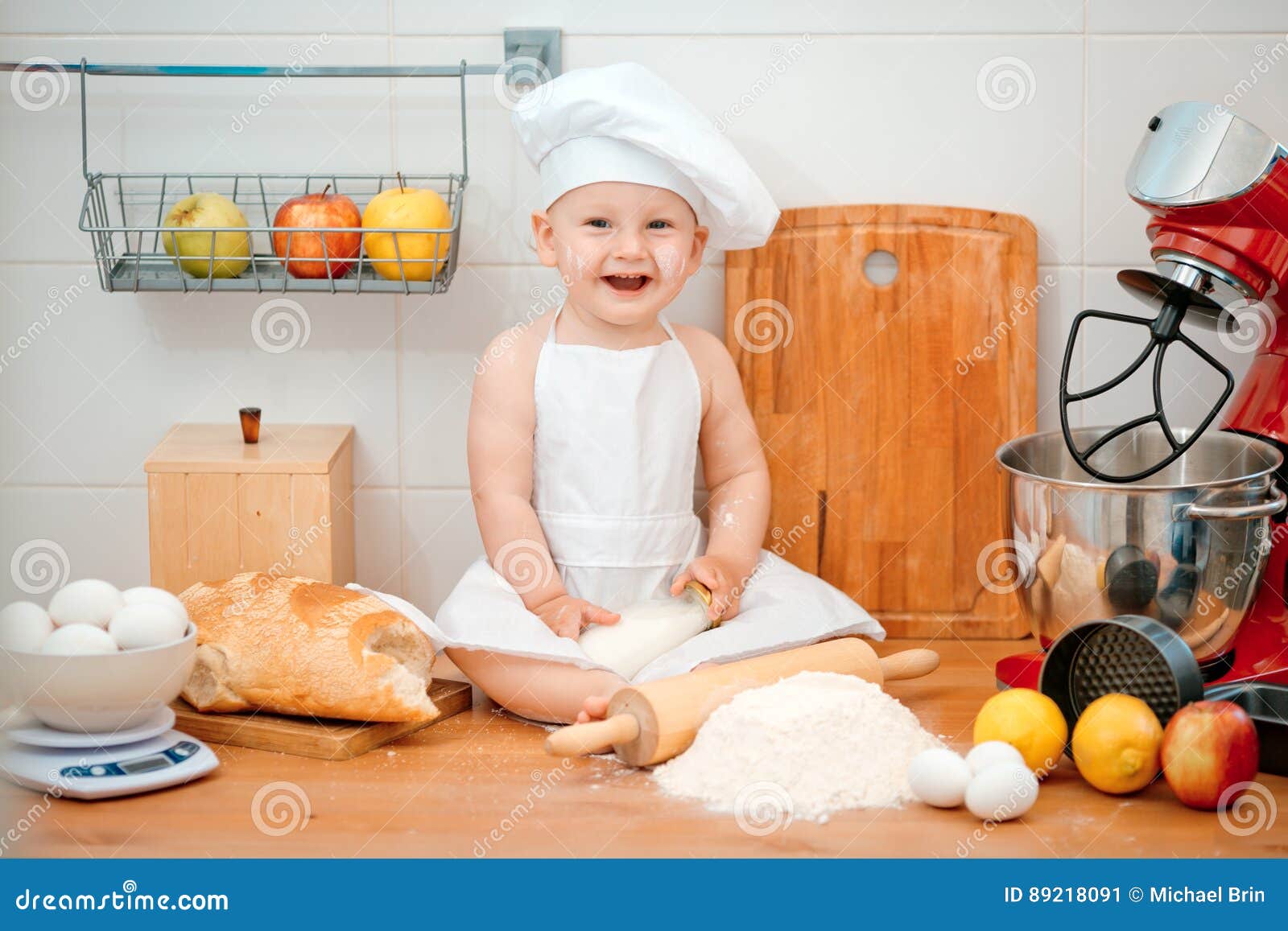 Little Boy in the Cook Costume at the Kitchen with Bread Stock Image ...
