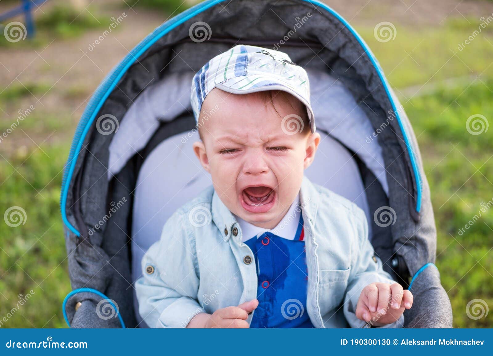 Little Boy Cries in a Stroller Stock Photo - Image of eyes, baby: 190300130