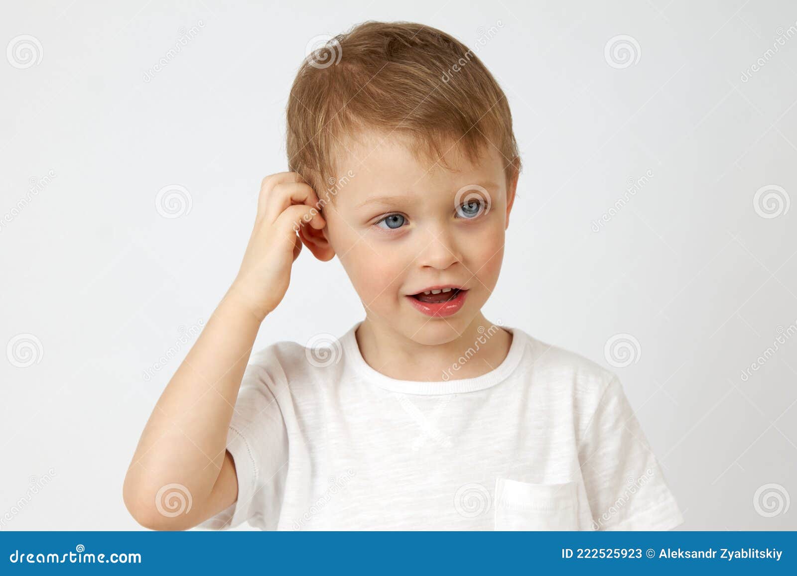 Little Boy is Deep in Thought and Scratching His Head on a White ...