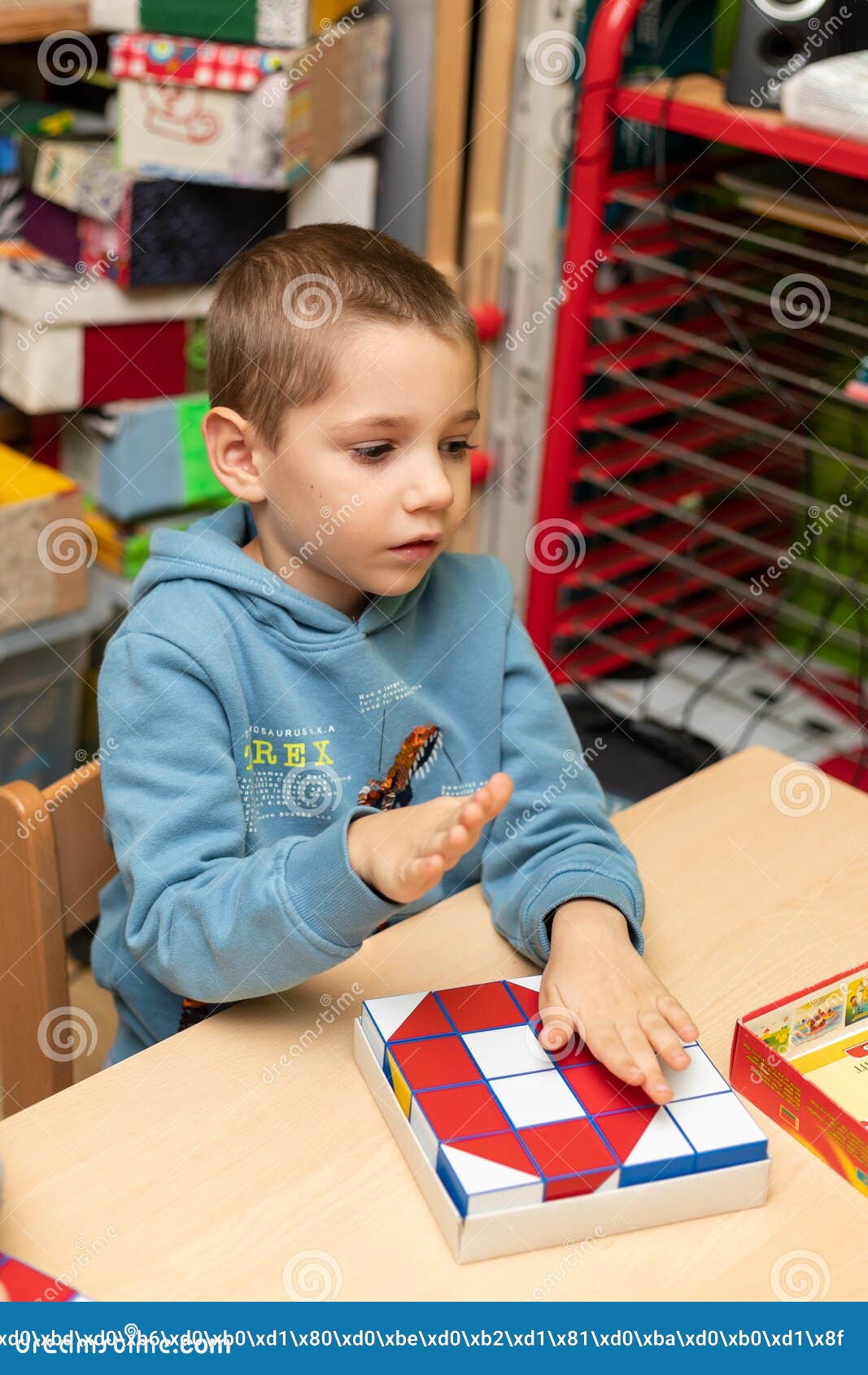 A Little Boy at a Desk Assembles a Letter from Blocks. Overall ...