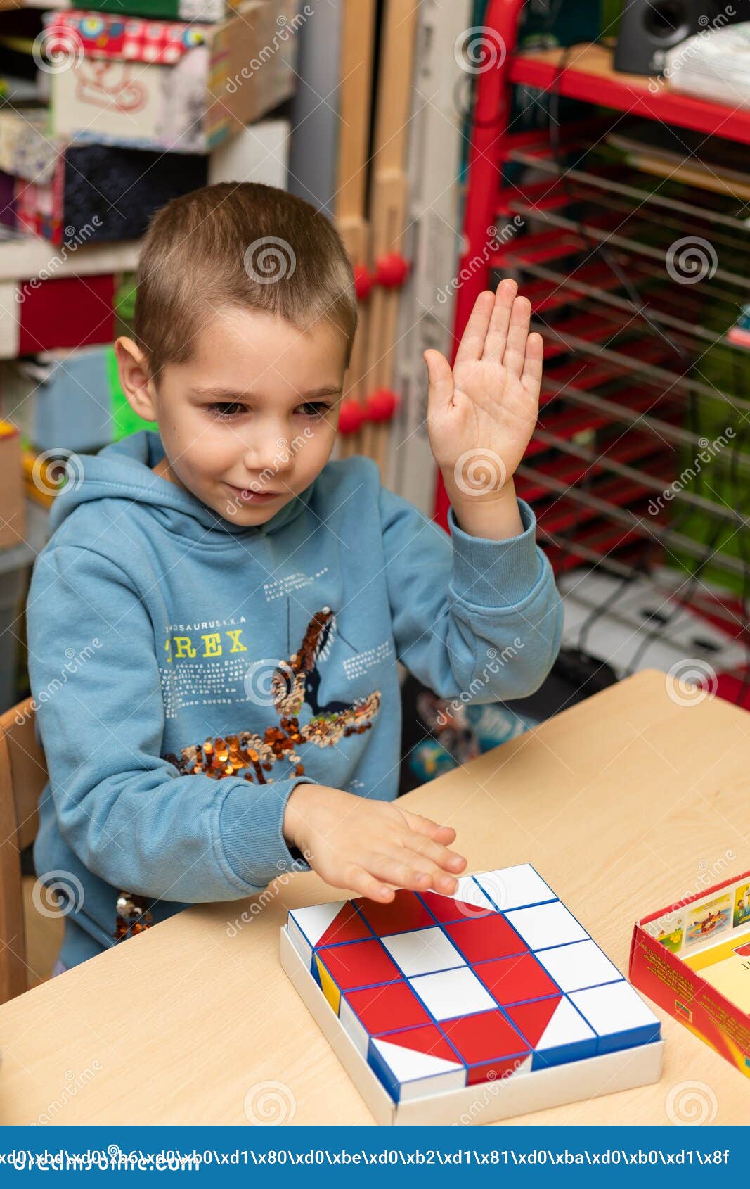 A Little Boy at a Desk Assembles a Letter from Blocks. Overall ...