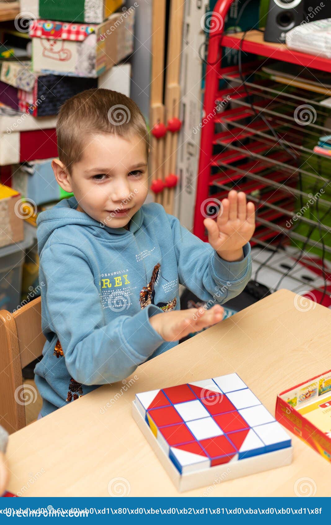 A Little Boy at a Desk Assembles a Letter from Blocks. Overall ...