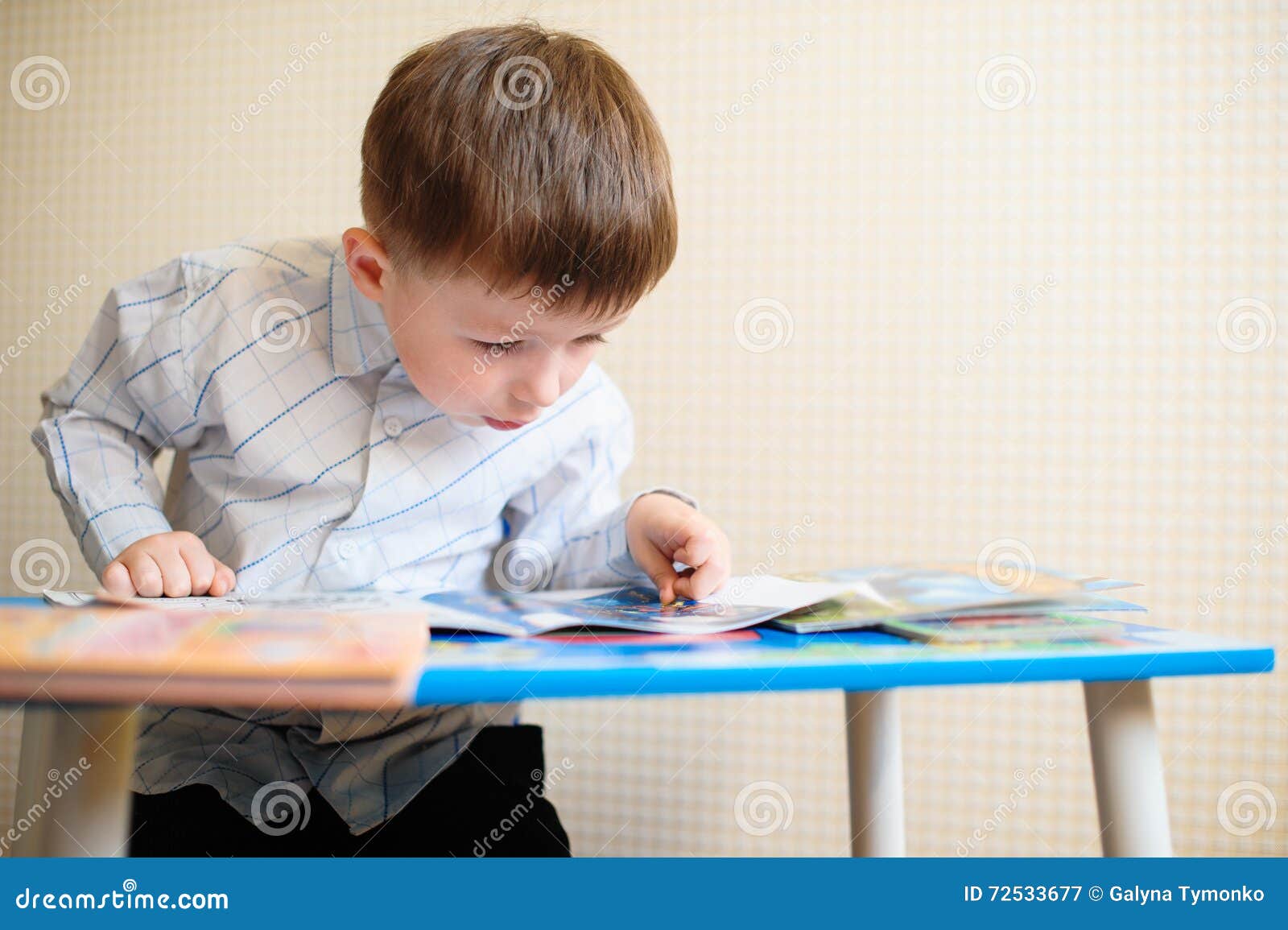 Little Boy at the Desk Reading a Book Stock Image - Image of notebook ...