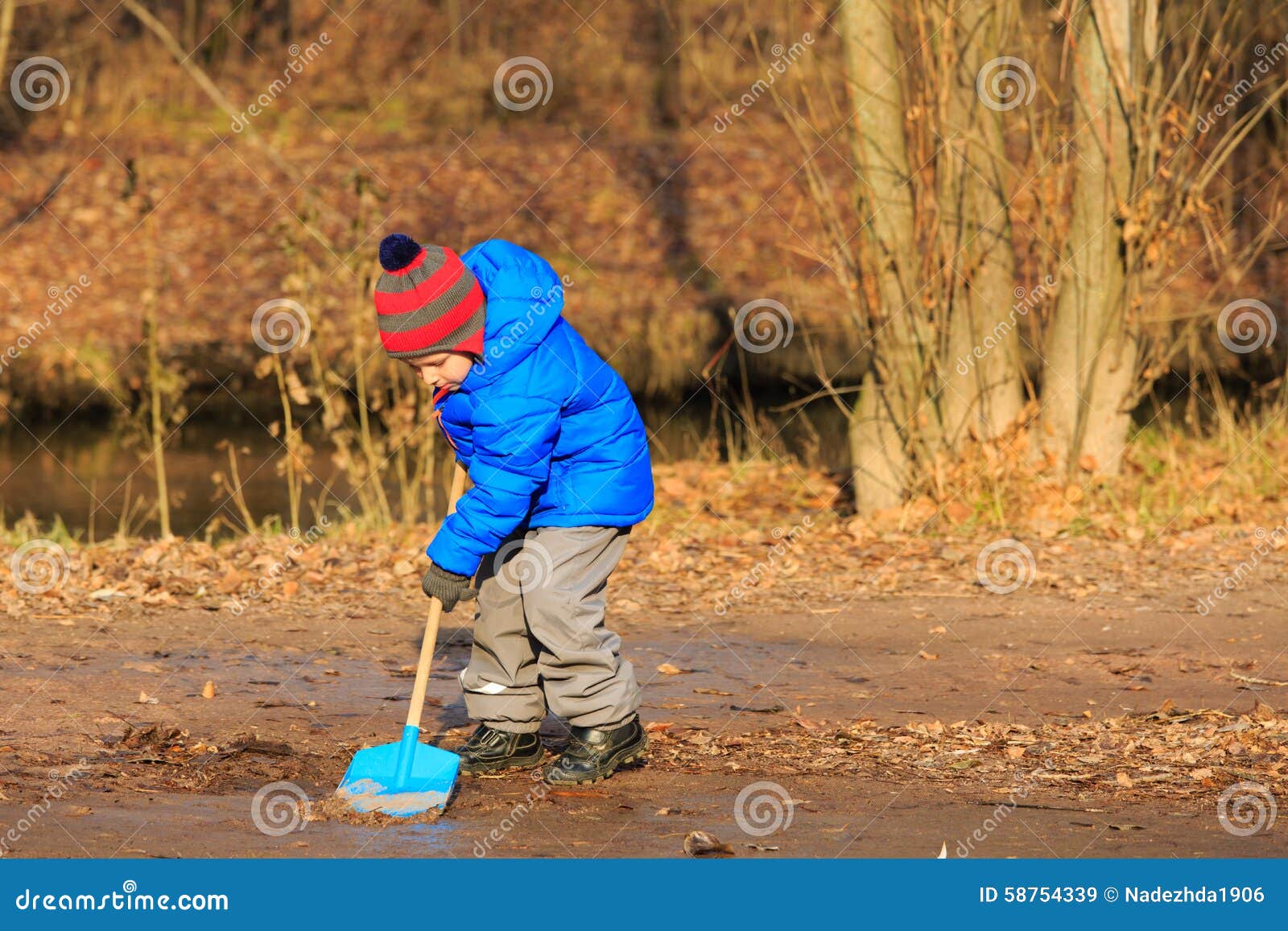 Little Boy Digging in Autumn Park Stock Image - Image of shovel, child ...