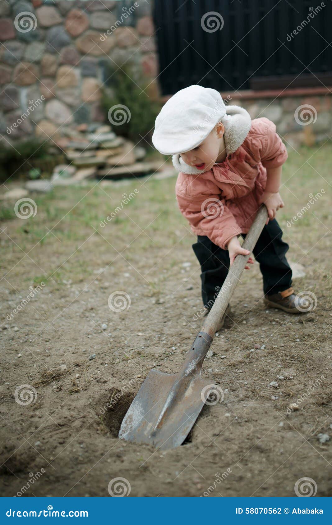 Little boy digging a hole stock photo. Image of outside - 58070562