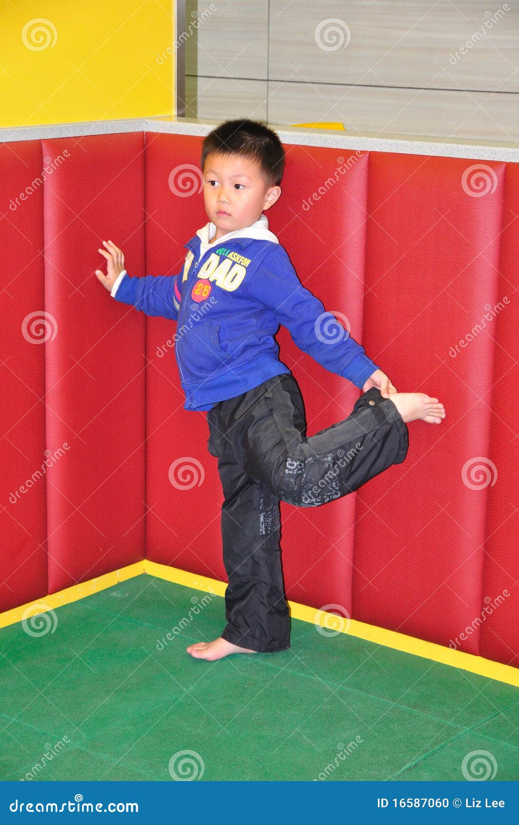 A Little Boy is Doing Some Exercise. Stock Photo - Image of standing ...