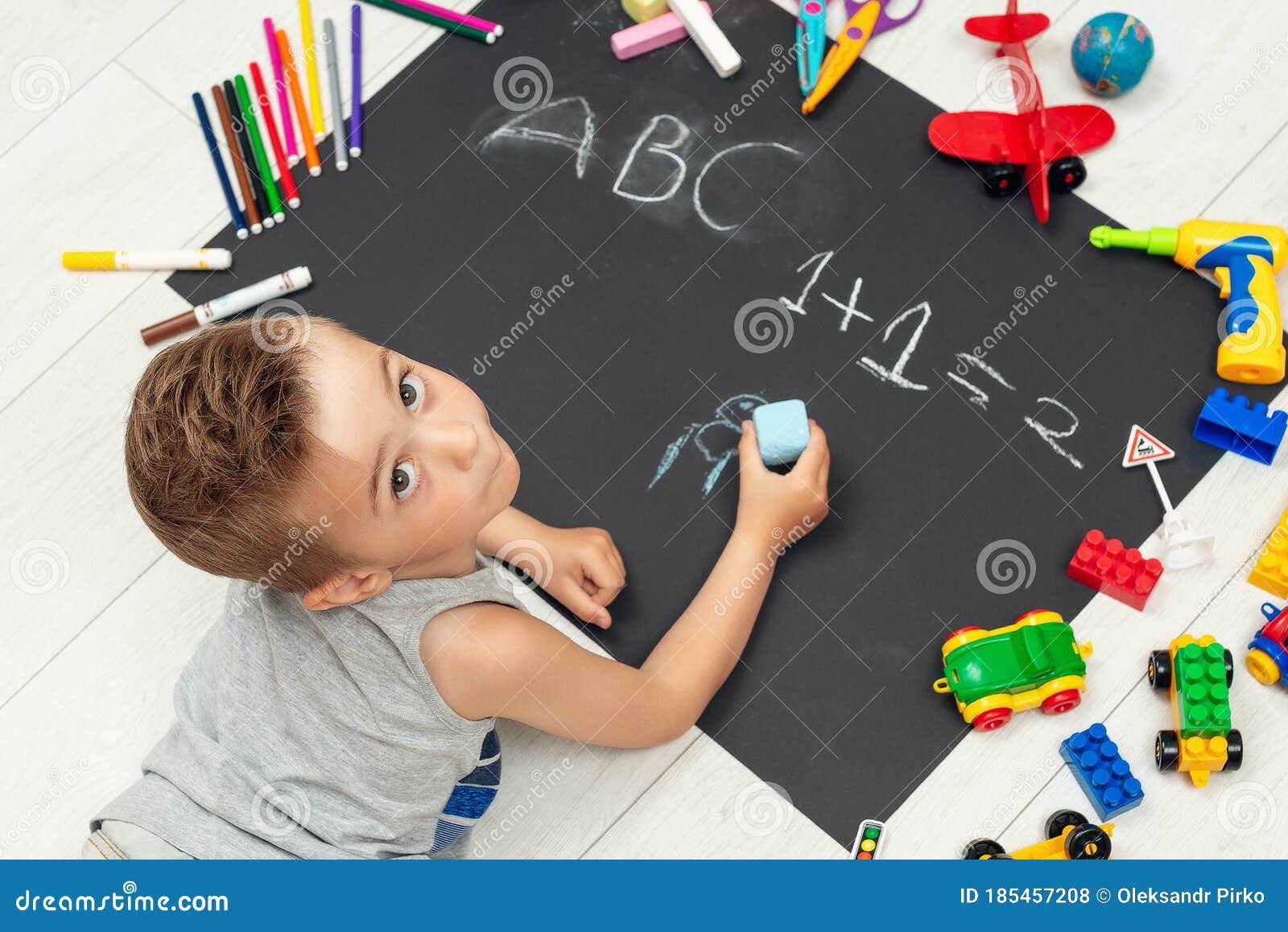 Little Boy Drawing with Chalk on Black Paper Stock Photo - Image of ...