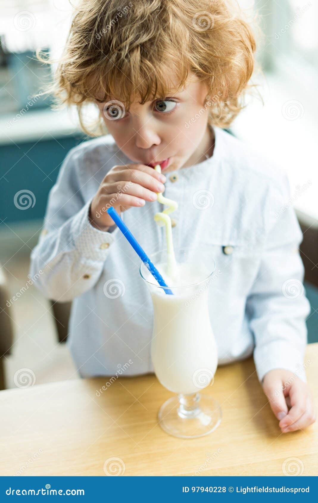 Little Boy Drinking Delicious Milkshake from Straw in Cafe Stock Photo ...