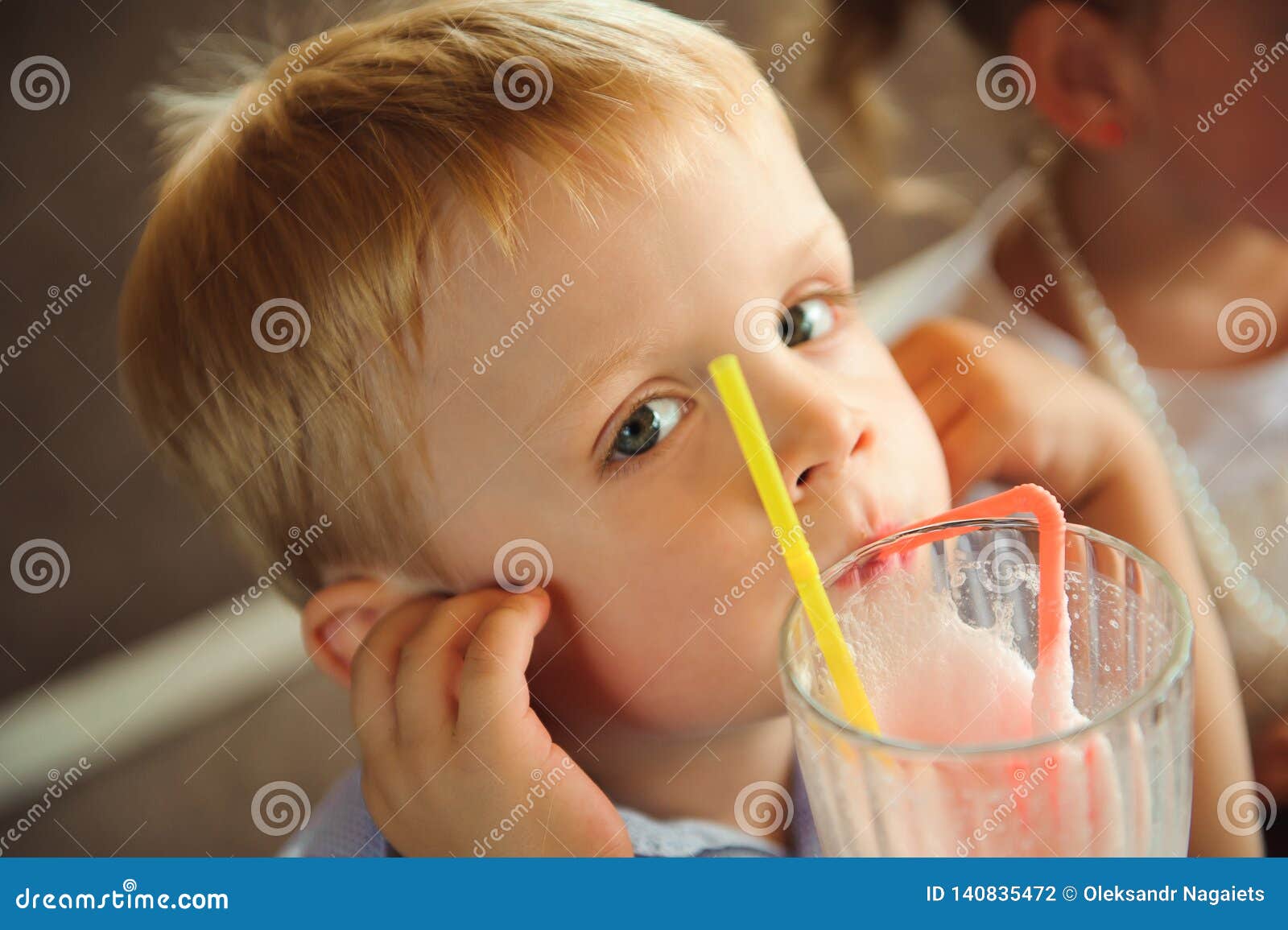Little Boy Drinking Milkshakes in a Cafe Outdoors. Stock Photo - Image ...
