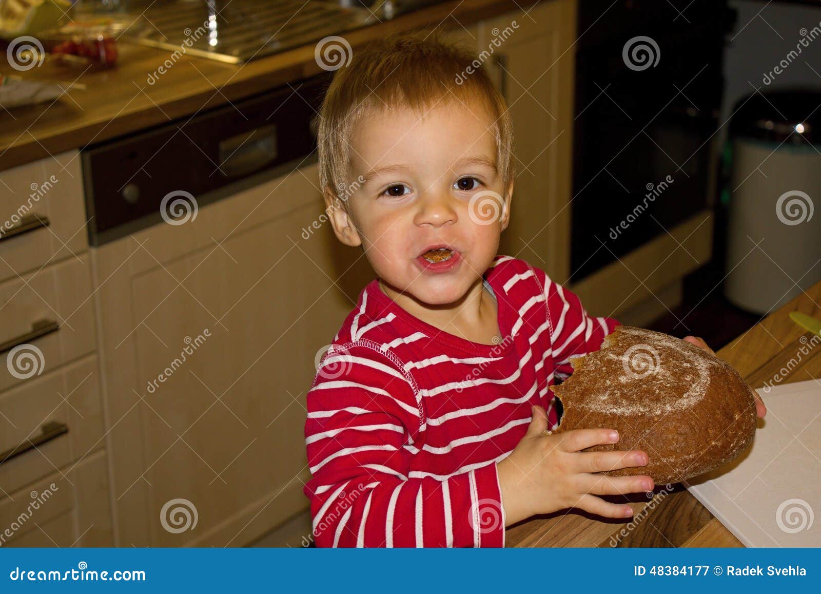Little boy eat bread stock image. Image of baby, bake - 48384177