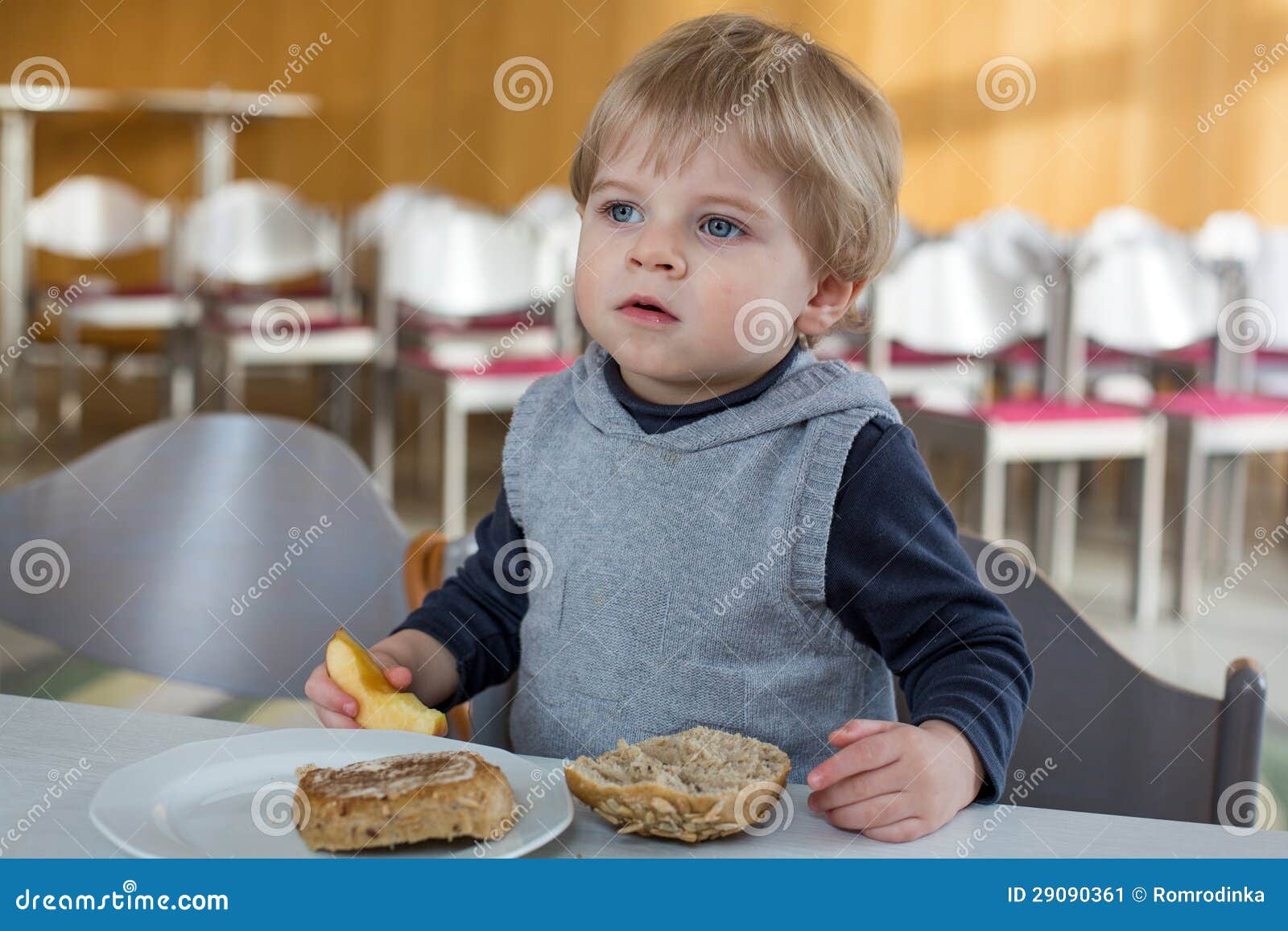 Little Boy with Eating Bread and Apple in Kindergarten Stock Image ...