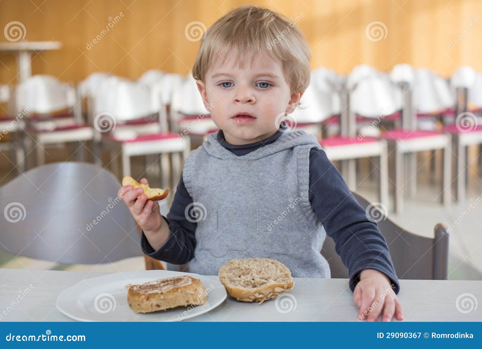 Little Boy with Eating Bread and Apple in Kindergarten Stock Image ...