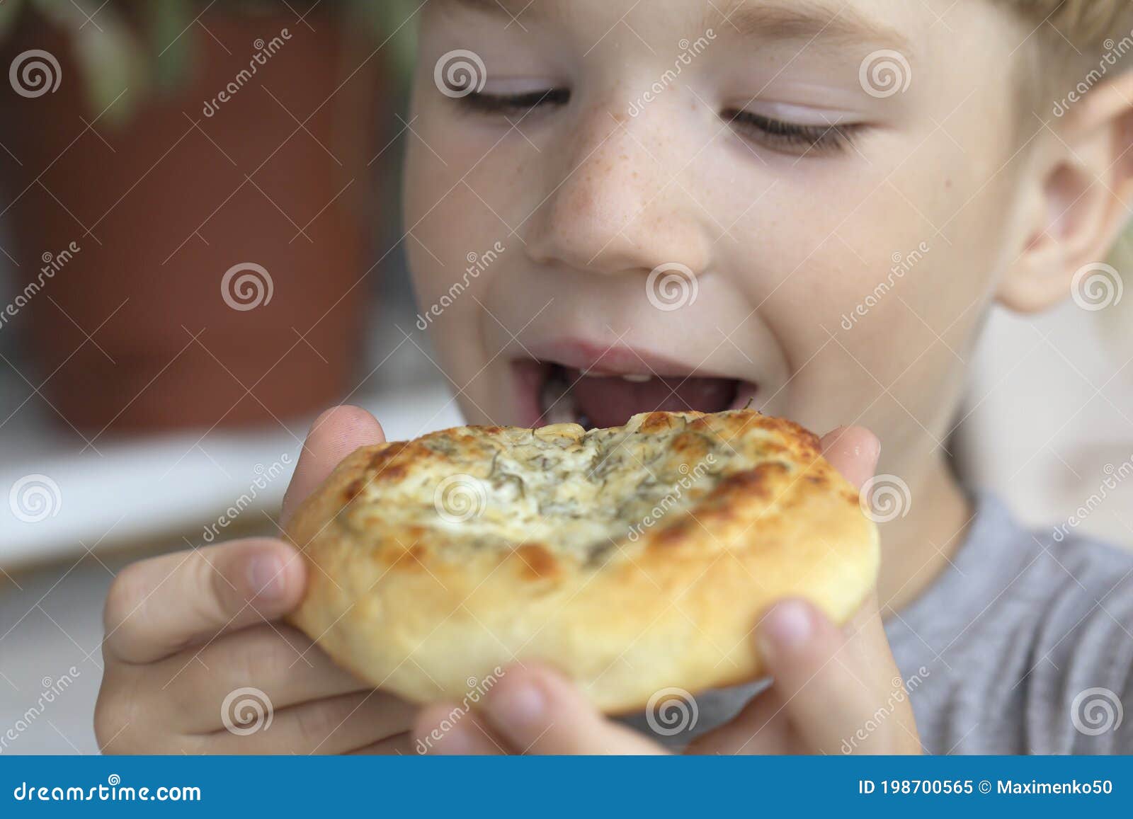 Little Boy Eating Cheese Bun in Cafe Outdoors Stock Image - Image of ...