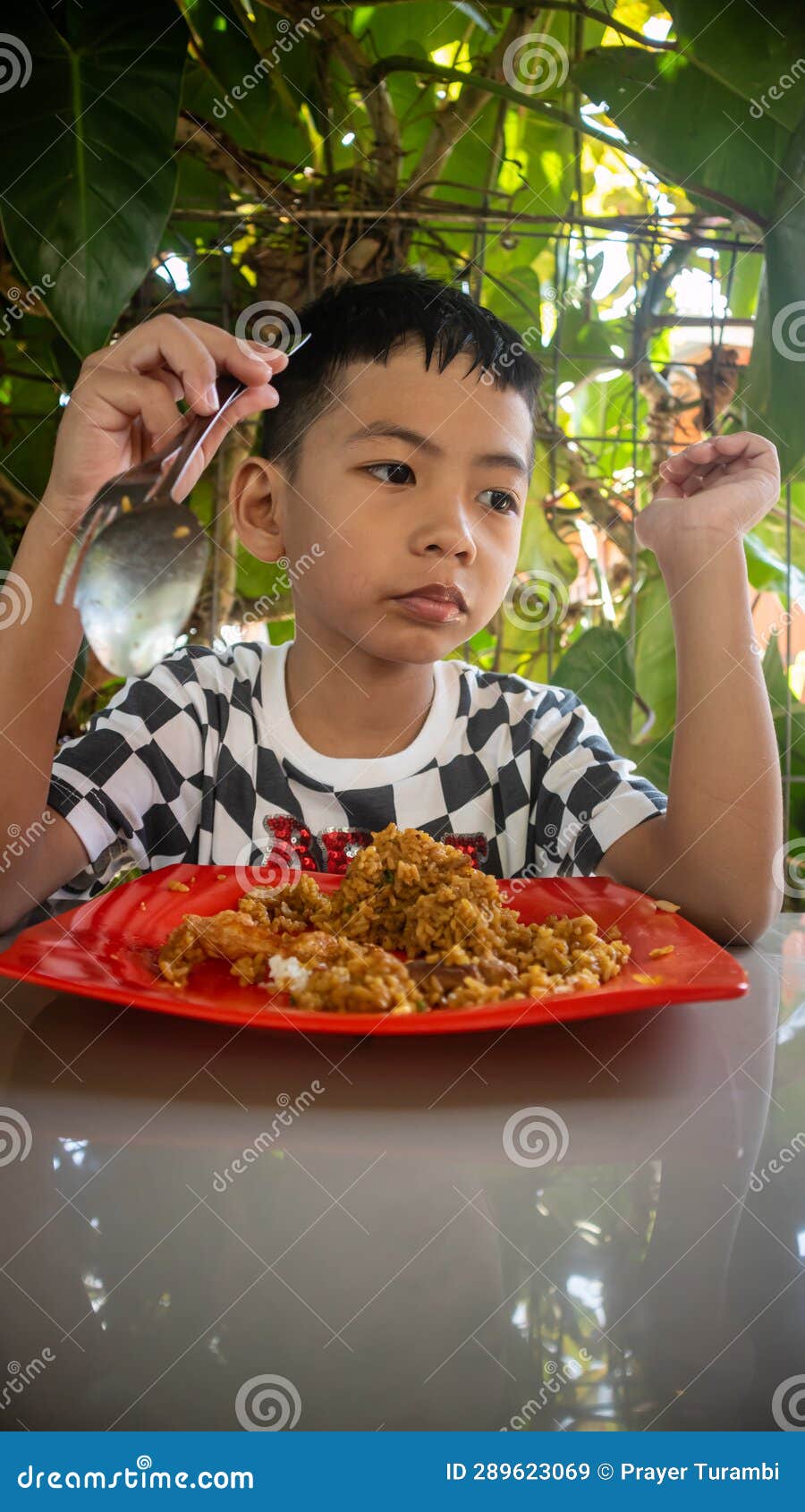 A Little Boy is Eating Fried Rice Stock Image - Image of holding ...