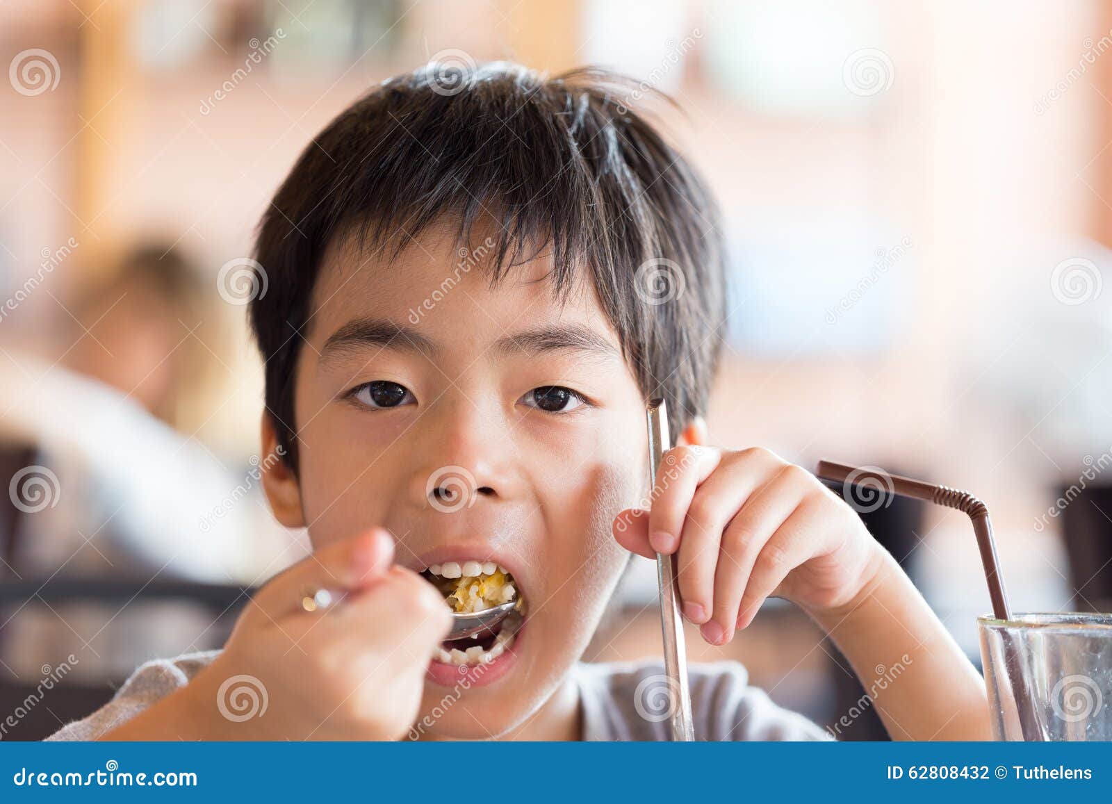 Little Boy Eating His Meal stock photo. Image of child - 62808432