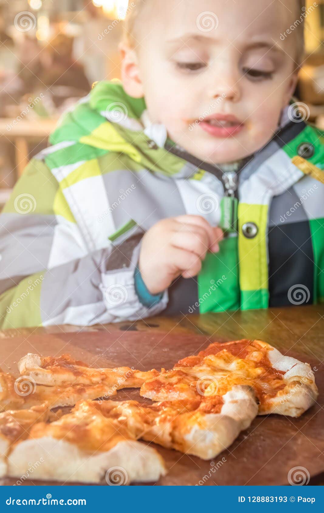 Little boy eating pizza stock image. Image of childhood - 128883193