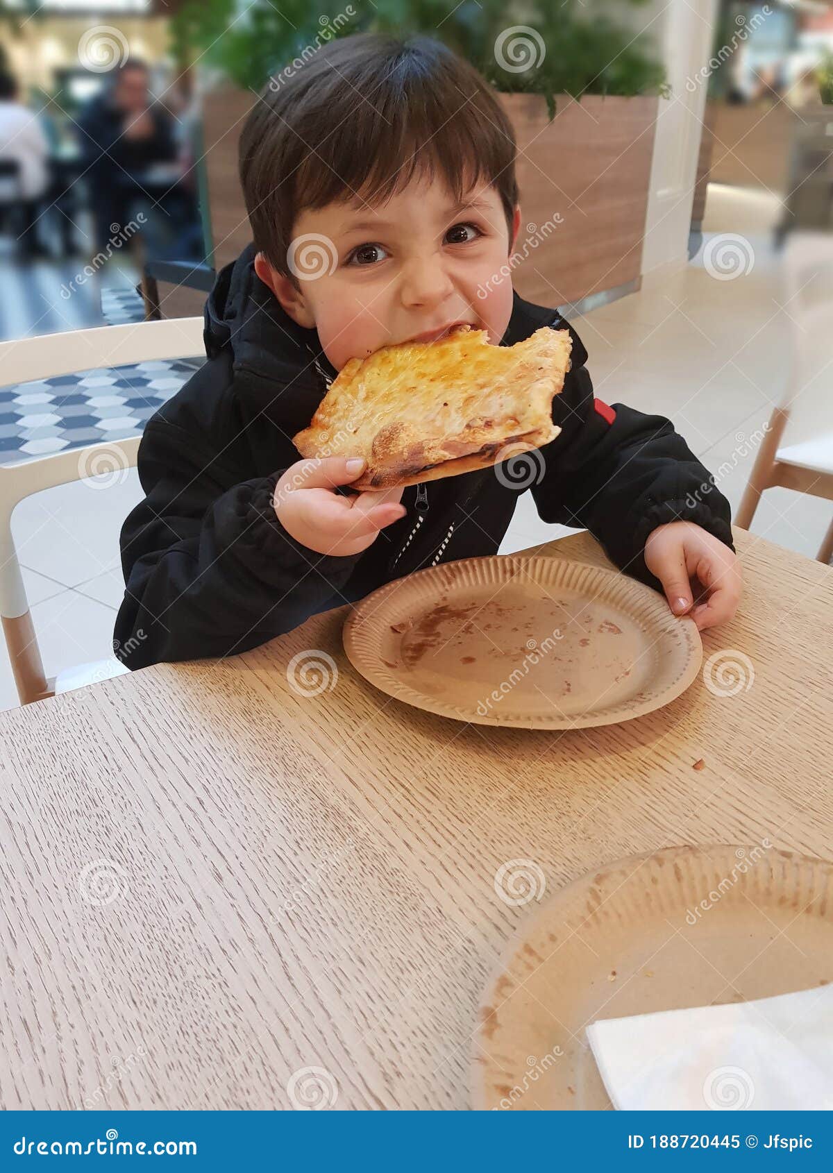 Little boy eating pizza stock image. Image of enjoying - 188720445