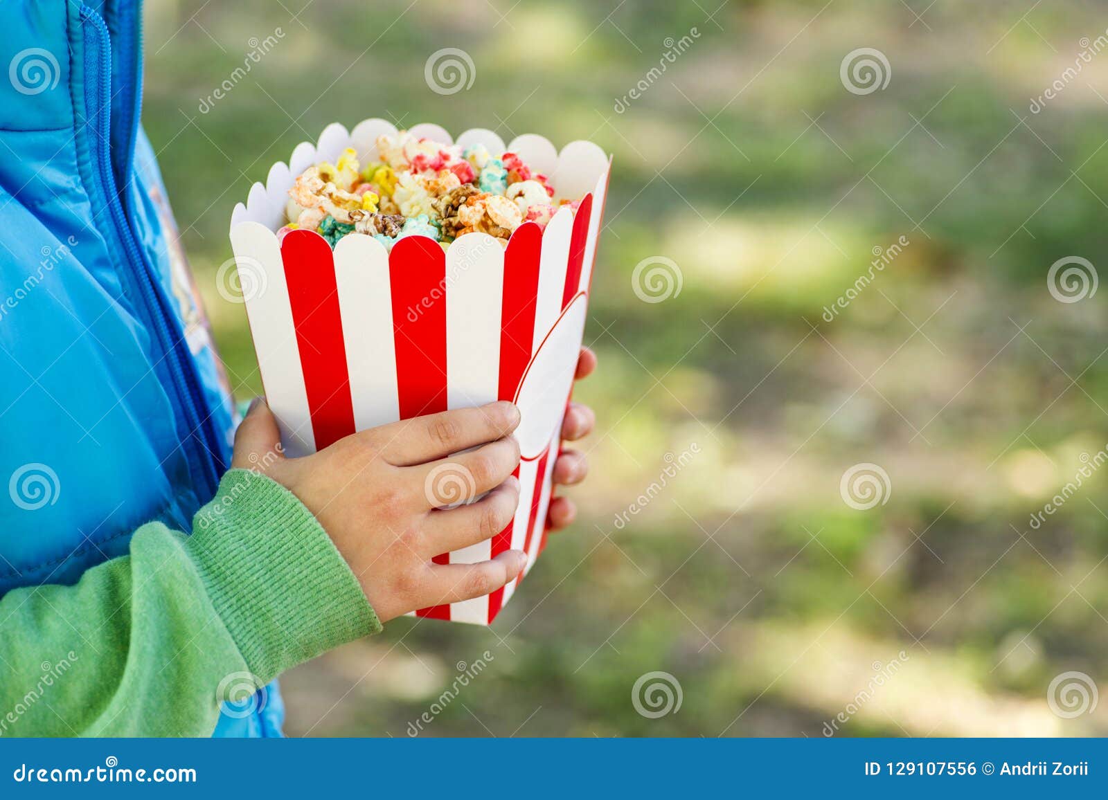 Little Boy Eating Popcorn. Little Boy Grabbing Popcorn from the Bucket ...