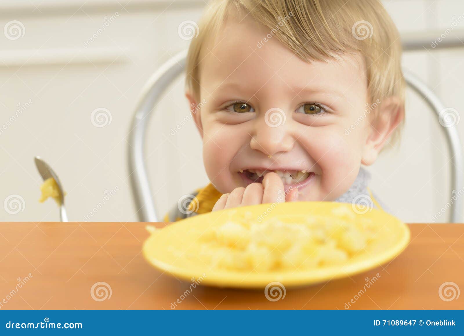 Little Boy Eating Potatoes stock image. Image of gourmet - 71089647