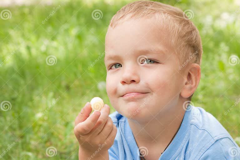 Little boy eating a snack. stock photo. Image of eyed - 14795072