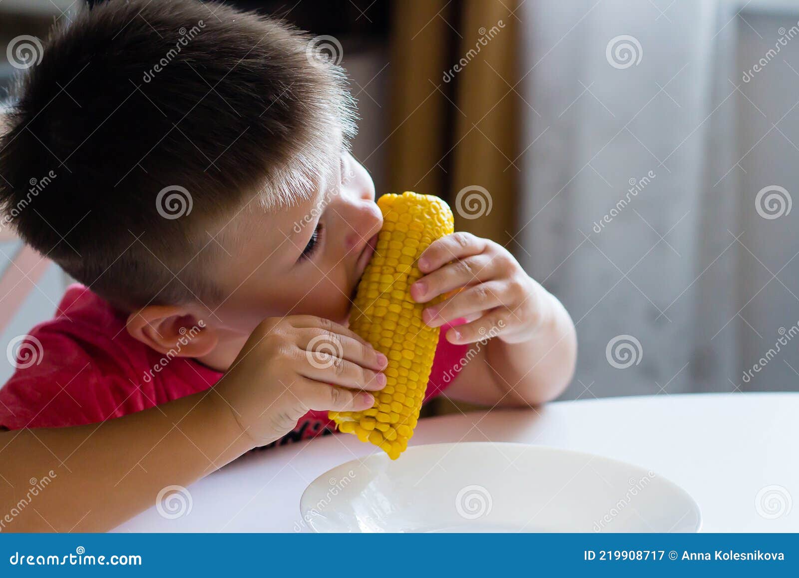 Little Boy Eats Corn at the Kitchen Stock Image - Image of nice ...