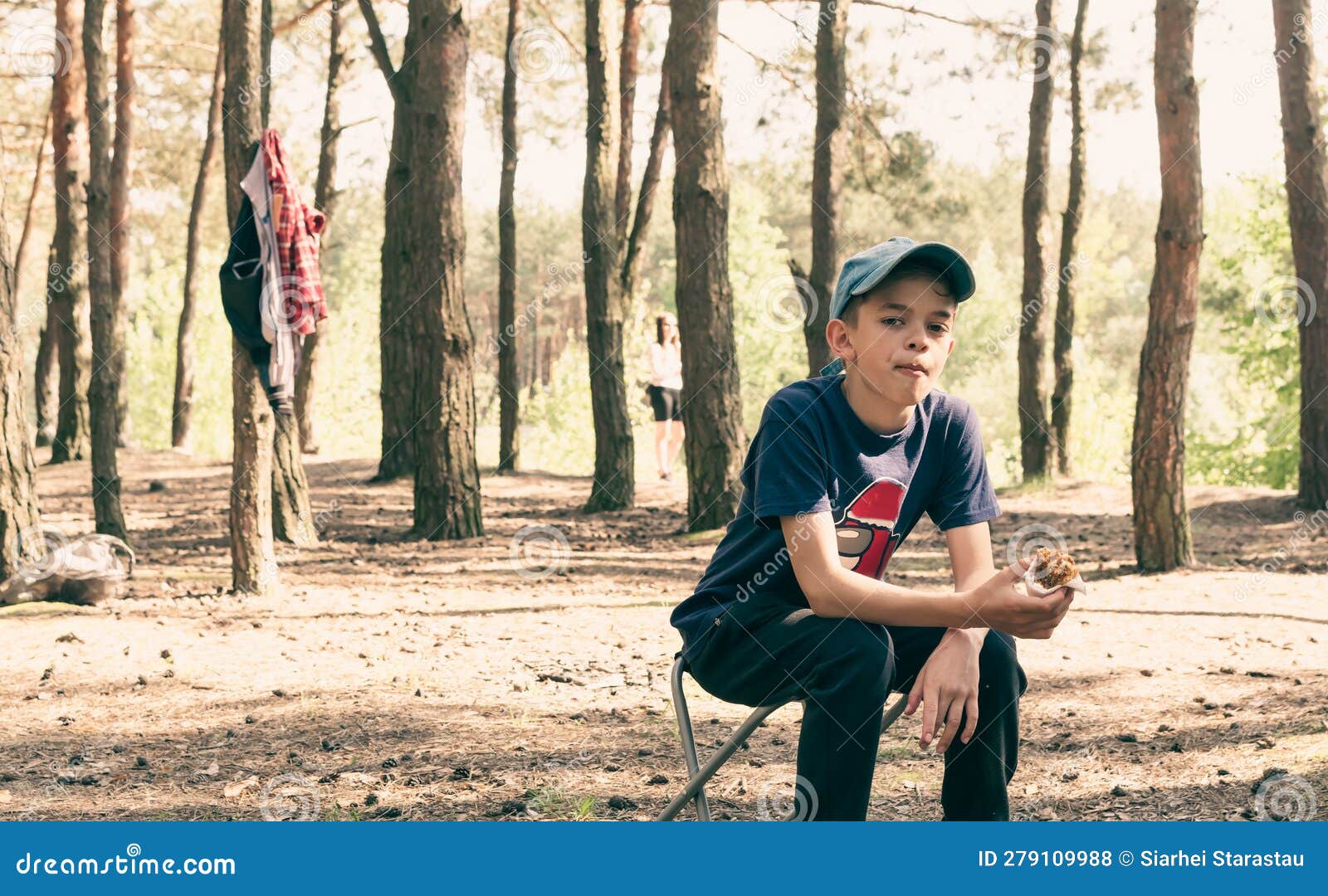 A Little Boy Eats in the Forest Stock Photo - Image of nature, forest ...