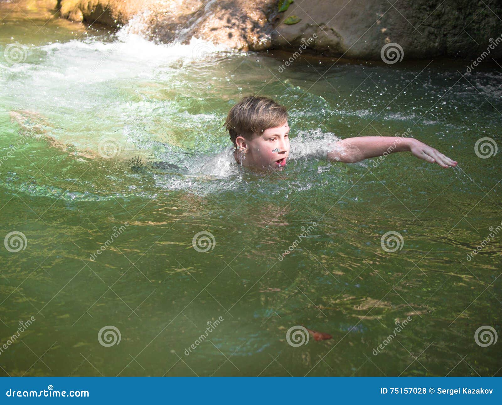Little Boy Floats on the Surface of the Water Stock Photo - Image of ...