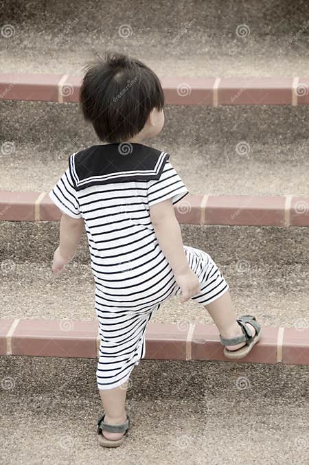 Little boy going up stairs stock photo. Image of child - 84060700