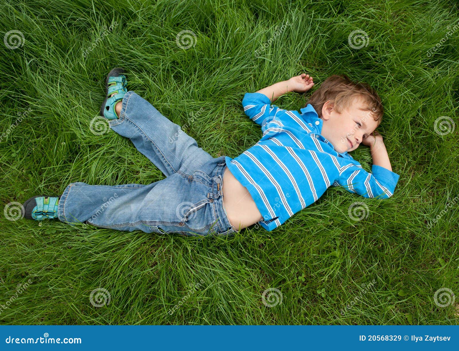 Little boy on grass stock image. Image of young, sandals - 20568329