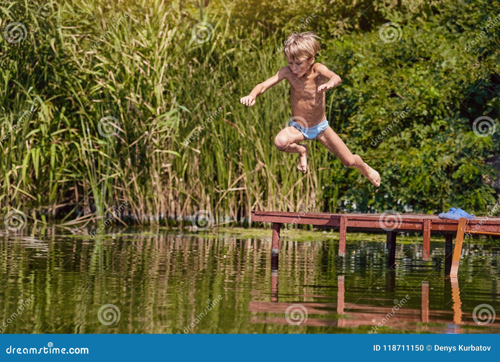 Boy jumping into the river stock photo. Image of healthy - 118711150