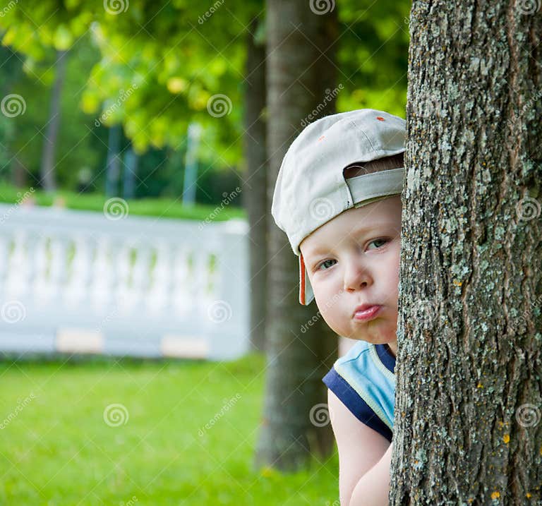 Little Boy Hiding Behind Tree Stock Image - Image of love, child: 33587315