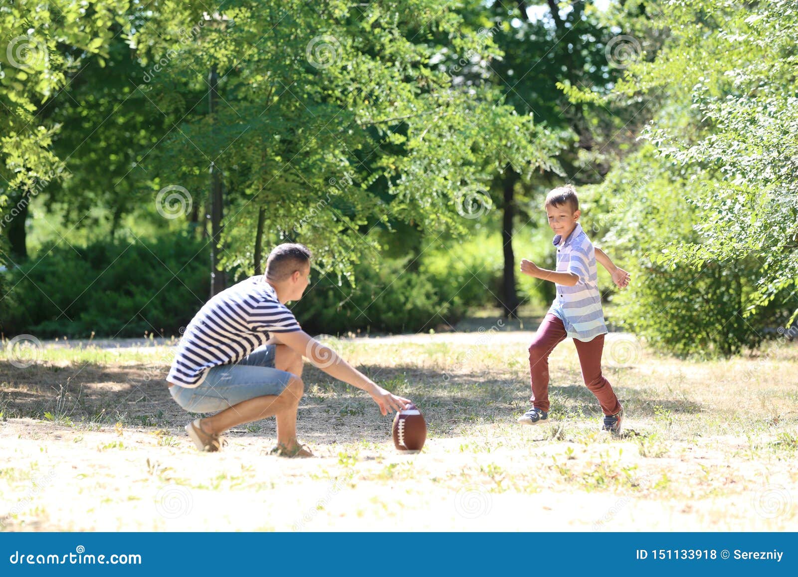Little Boy with His Dad Playing Rugby Outdoors Stock Photo - Image of ...