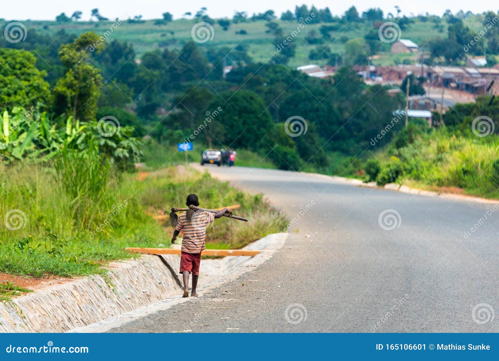 A Boy with a Hoe is Walking Down a Street in Uganda Stock Image - Image ...