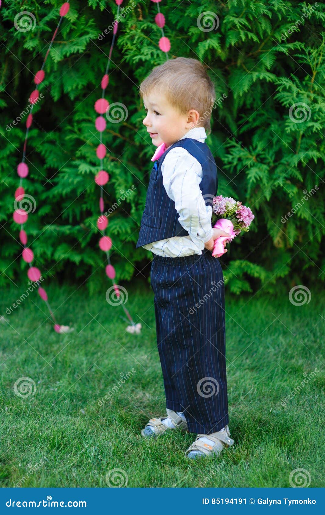 Little Boy Holding a Bouquet of Flowers in the Park Stock Image - Image ...