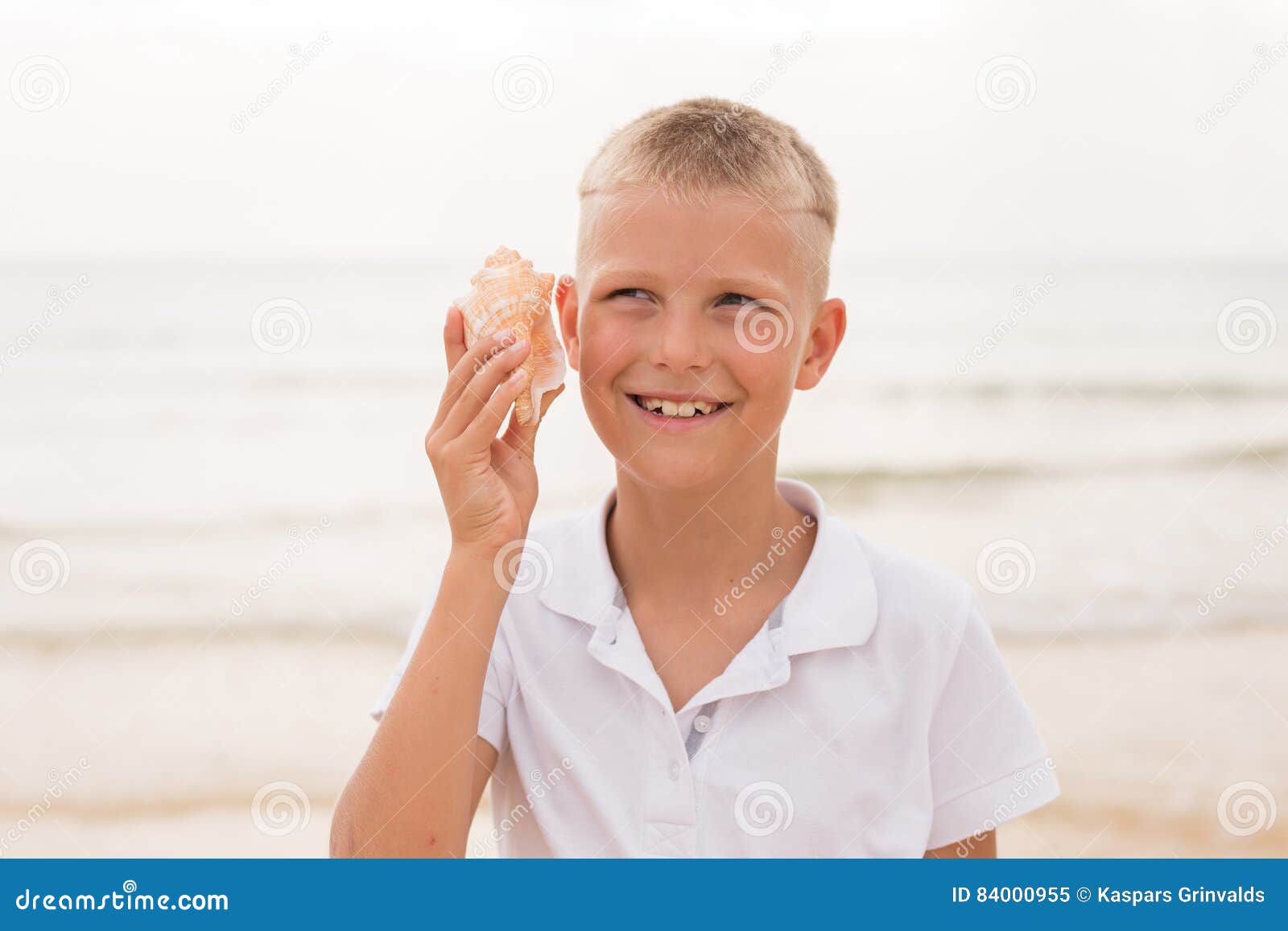 Little Boy Holding a Seashell Stock Image - Image of beach, creative ...