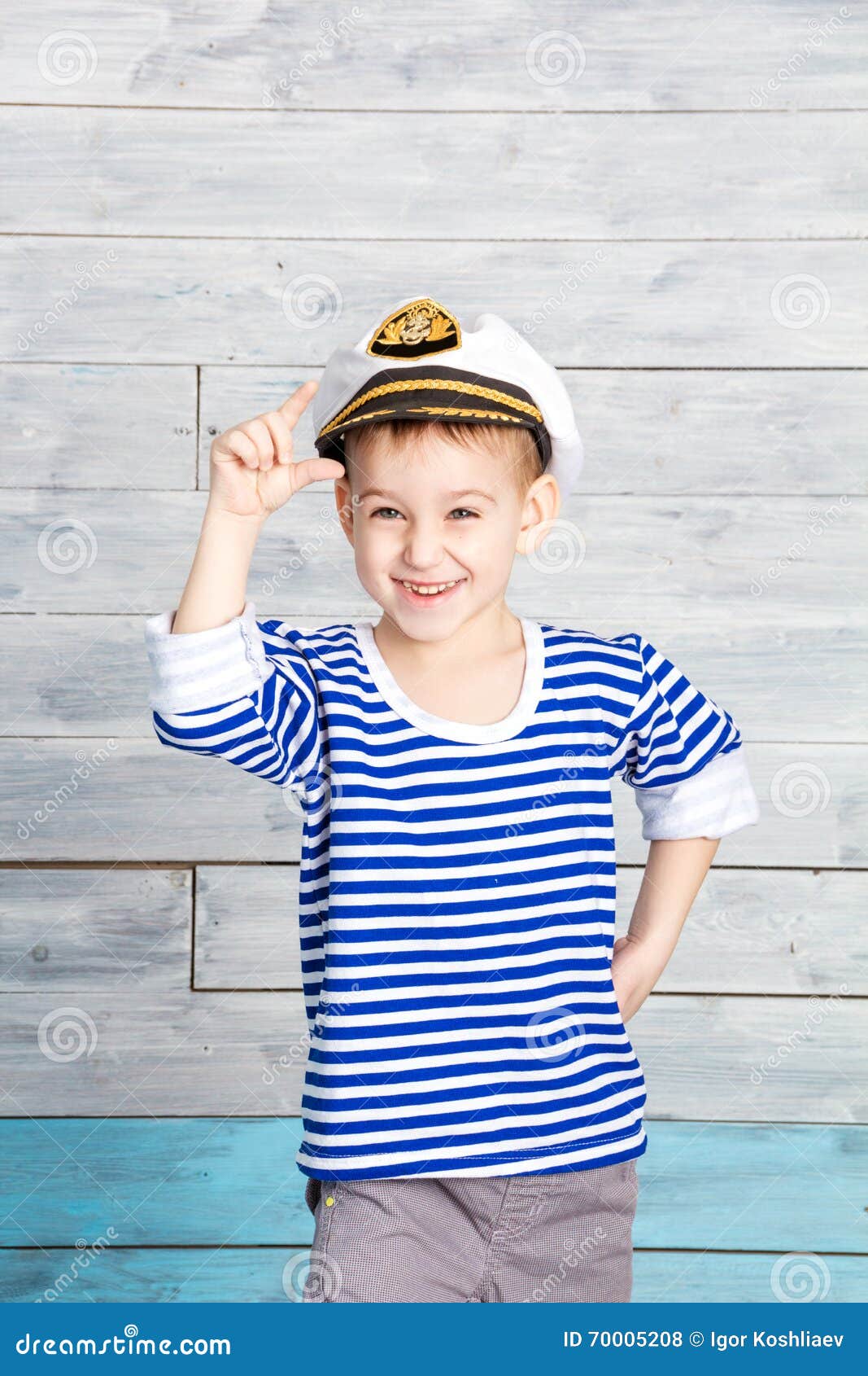 Little Boy Holding on To His Cap and Laughs Stock Photo - Image of ...