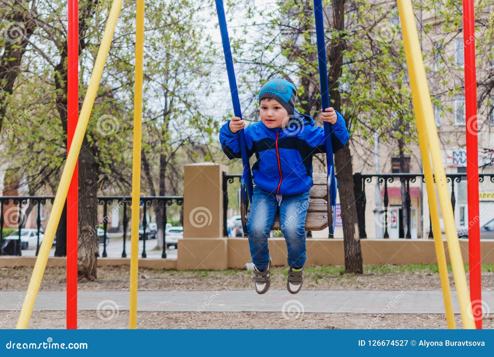 A Little Boy Riding on a Swing in the Park Stock Image - Image of ...