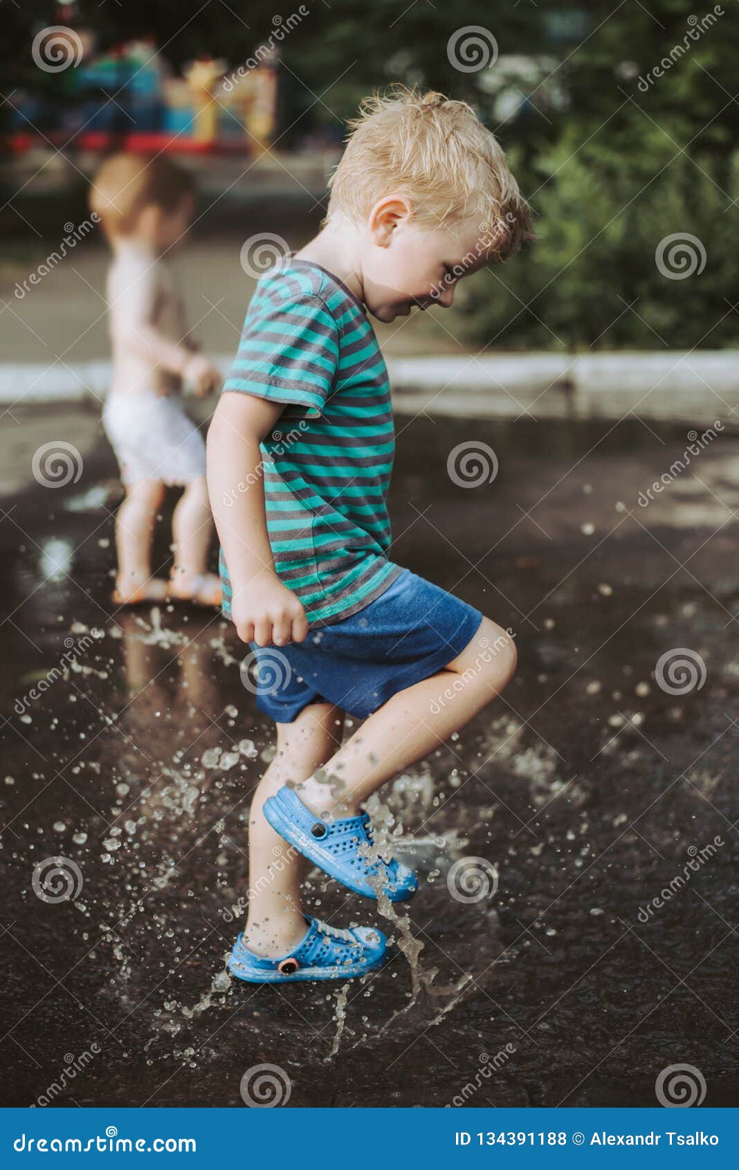 Little Boy Jumping in a Puddle in Summer Stock Photo - Image of happy ...