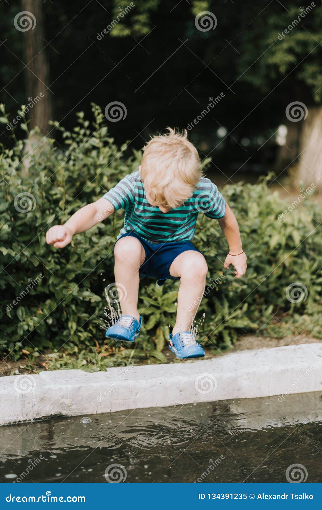 Little Boy Jumping in a Puddle in Summer Stock Image - Image of ...