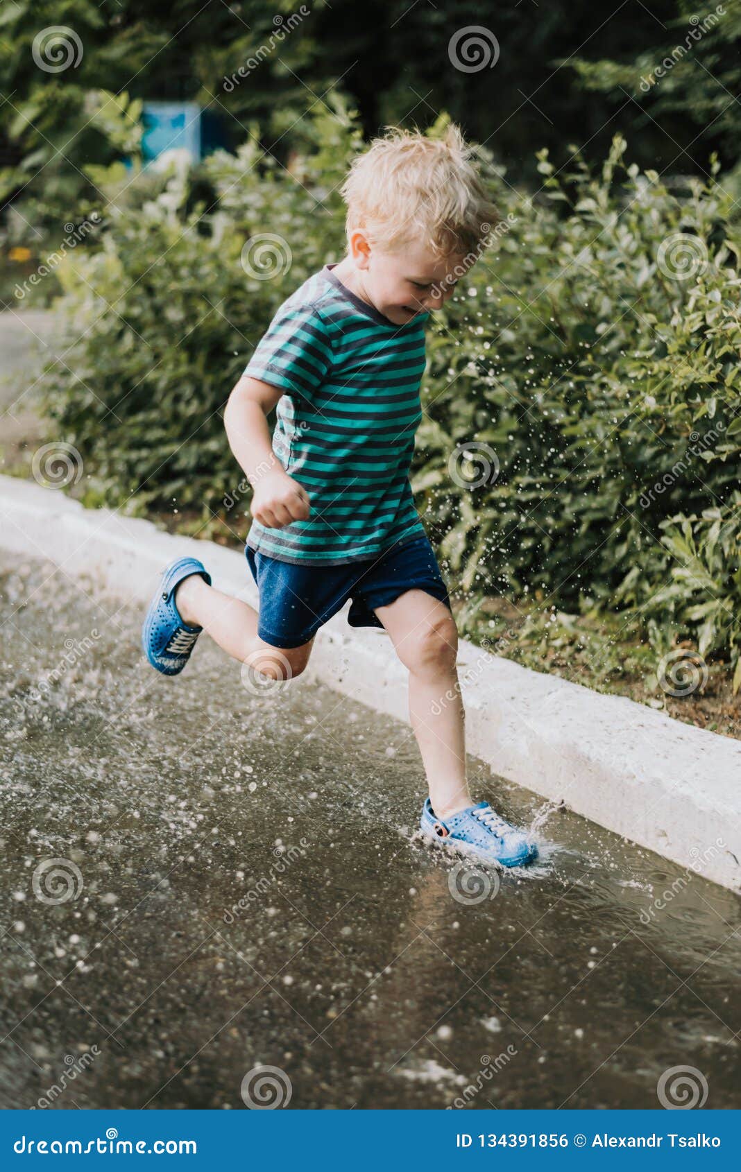 Little Boy Jumping in a Puddle in Summer Stock Photo - Image of rain ...