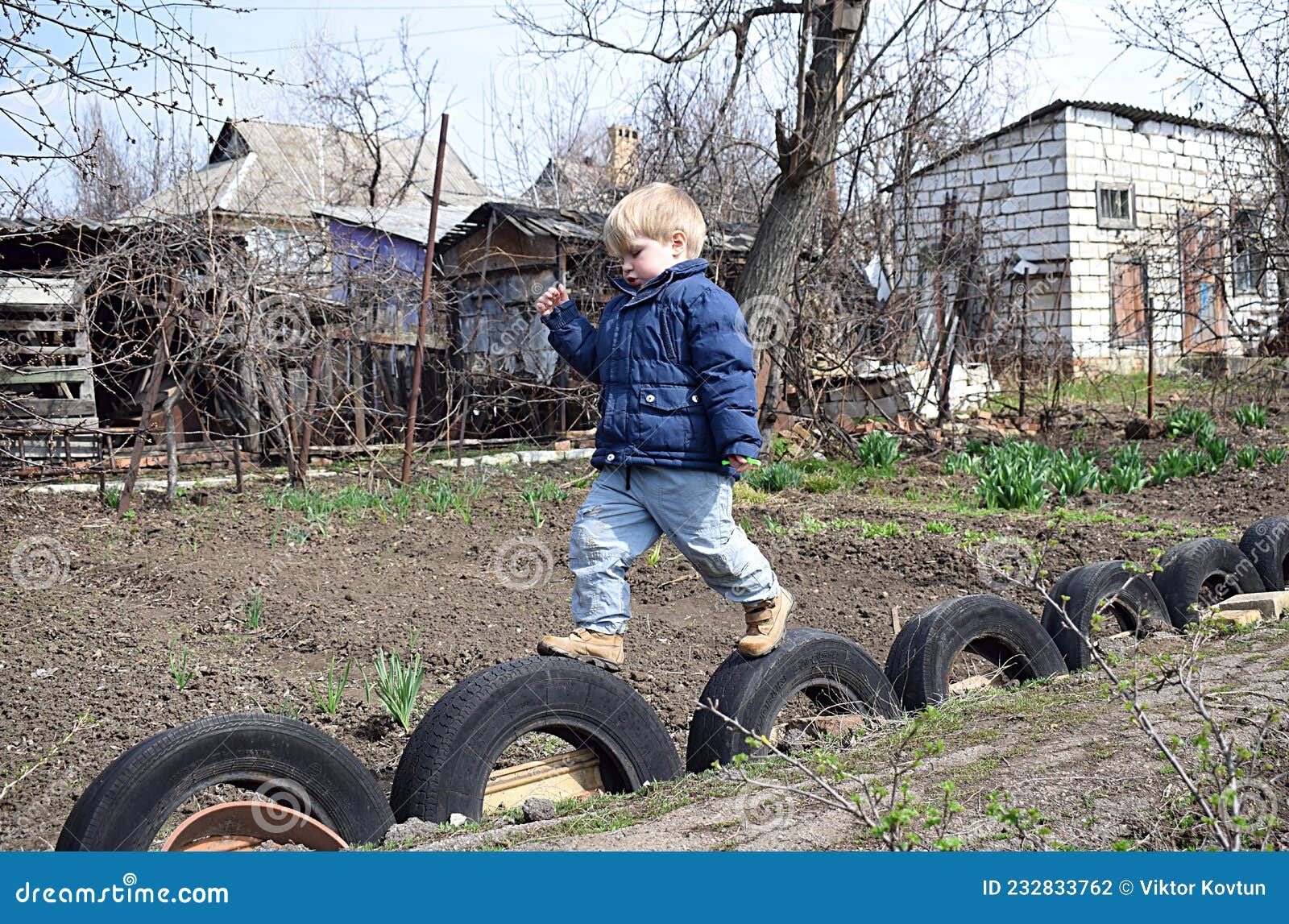 Little Boy Jumping on Tires Stock Photo - Image of play, autumn: 232833762