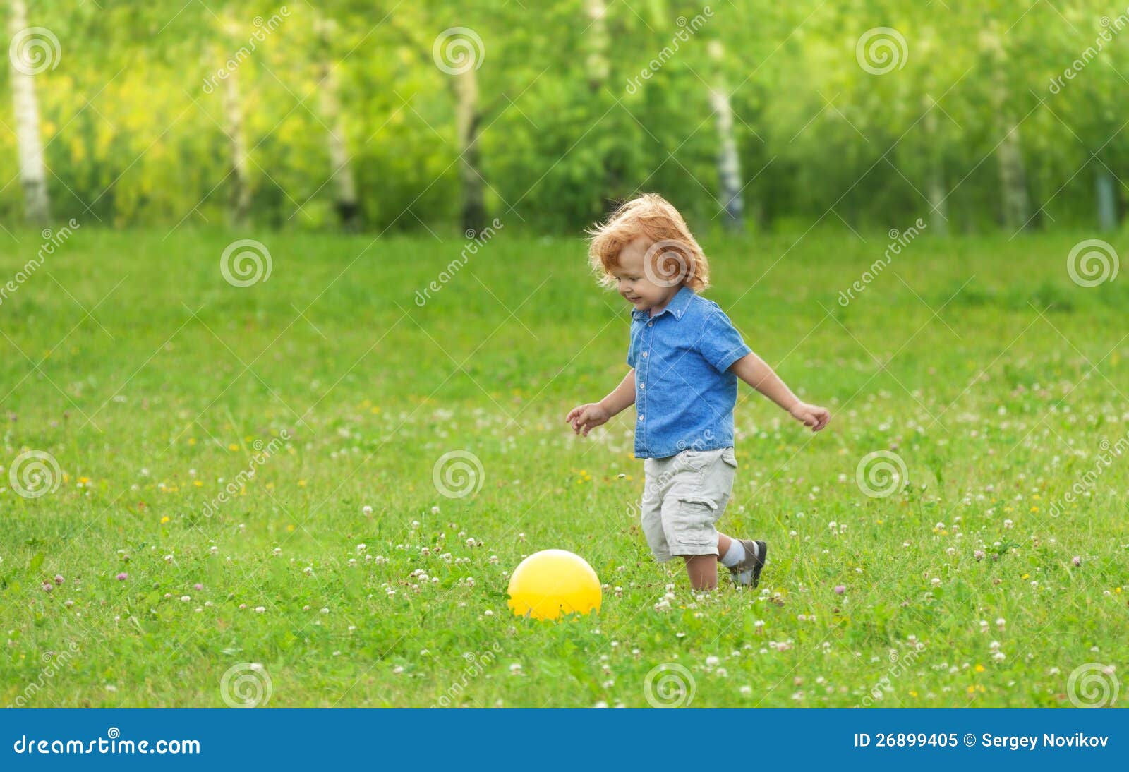 Little Boy Kicking Yellow Ball Stock Image - Image of happy, nature ...