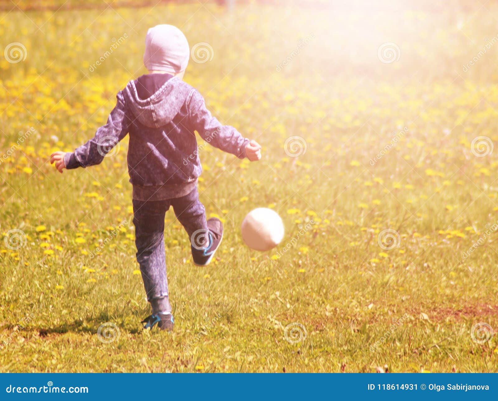 Little Boy Kicks a Ball on the Grass Stock Image - Image of kick ...
